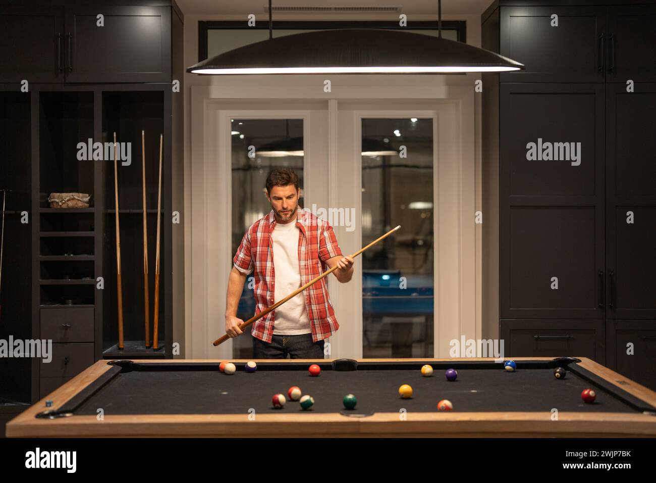 Man Playing the billiards. Man play american billiard in Billiard room ...