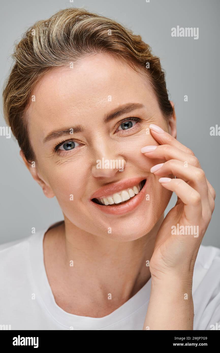 joyous good looking woman with contact lenses and blonde hair looking ...