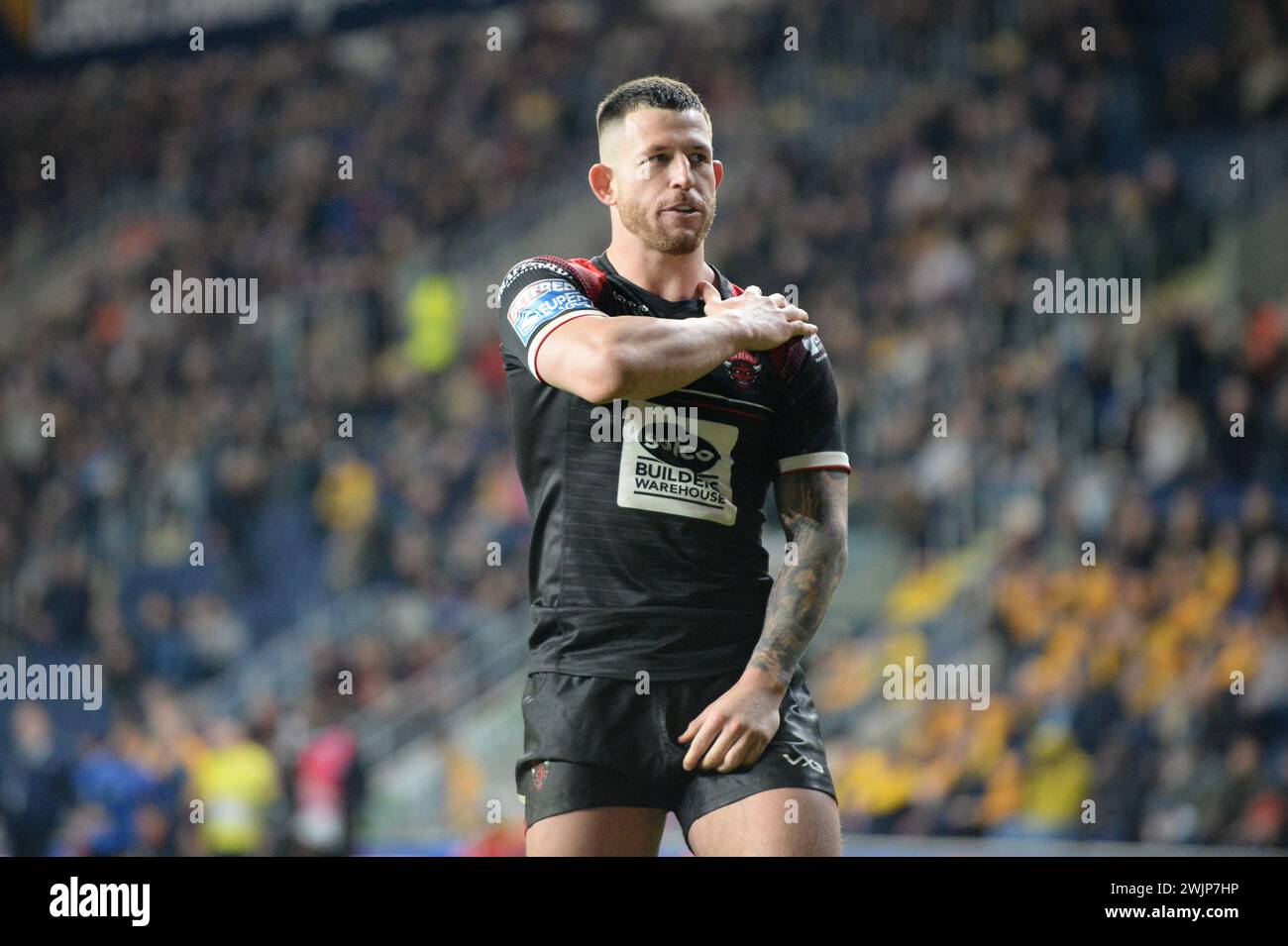 Cade Cust of Salford Red Devils holds his shoulder after a tackle ...