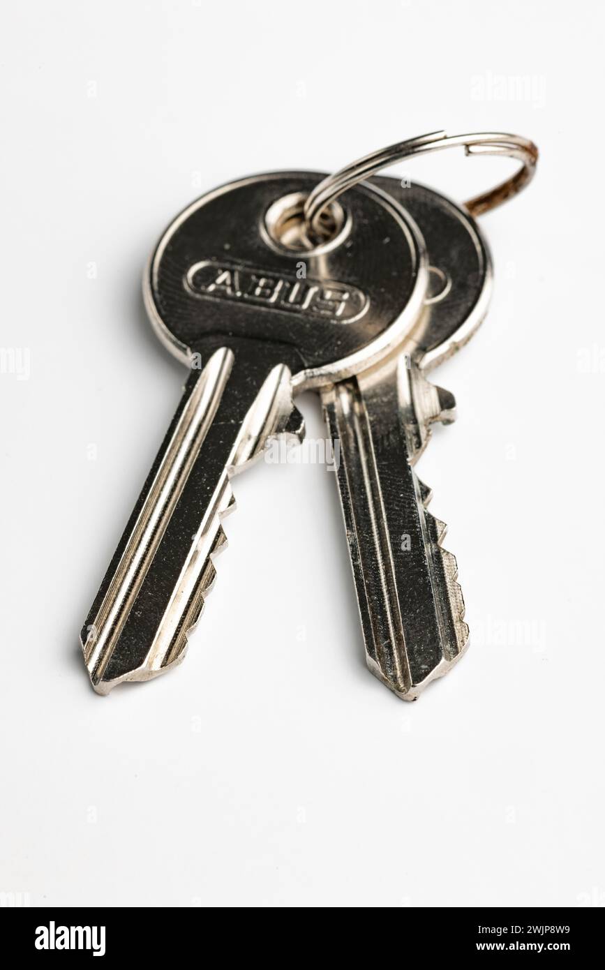 Key ring with two keys on a key ring, white background Stock Photo - Alamy