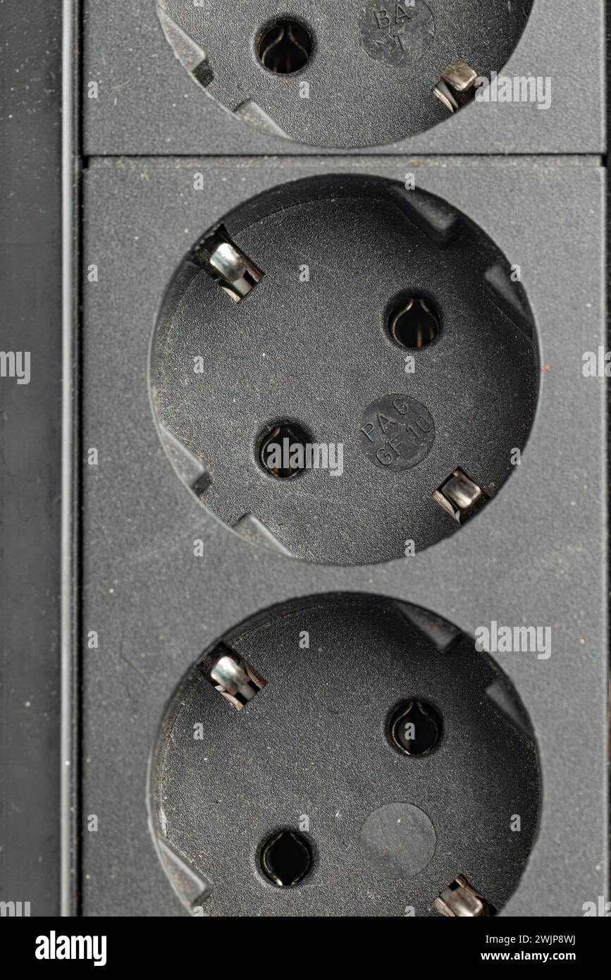 Close-up of sockets in a black socket strip Stock Photo - Alamy
