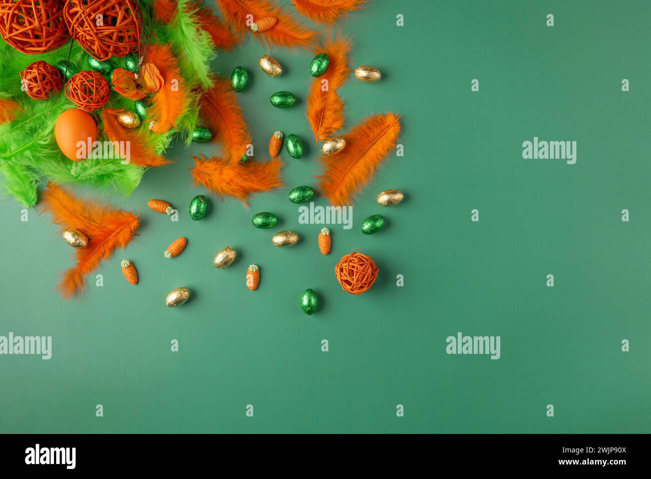 Spring-like Easter arrangement with feathers and chocolate eggs in ...