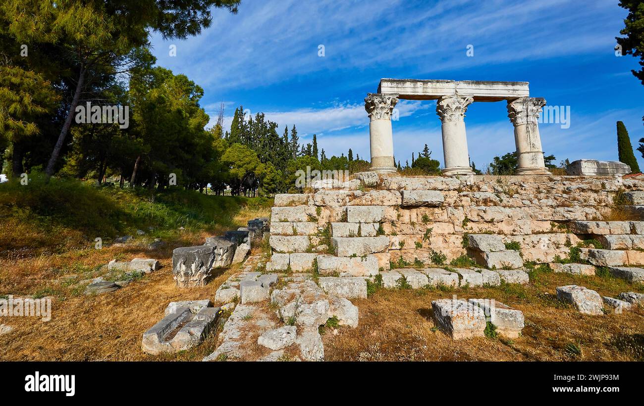 Columns and ruins of an ancient site under a bright blue sky flanked by ...