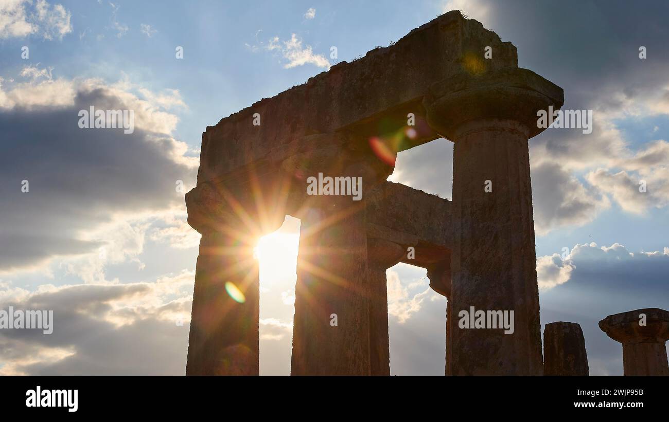 Archaic Temple of Apollo, Doric columns, Sunset behind ancient ruins with shining columns ...