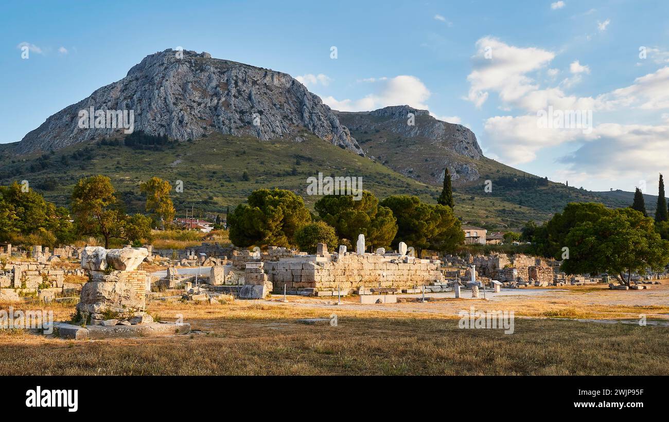 Ancient ruins in front of an imposing mountain and a light blue sky ...