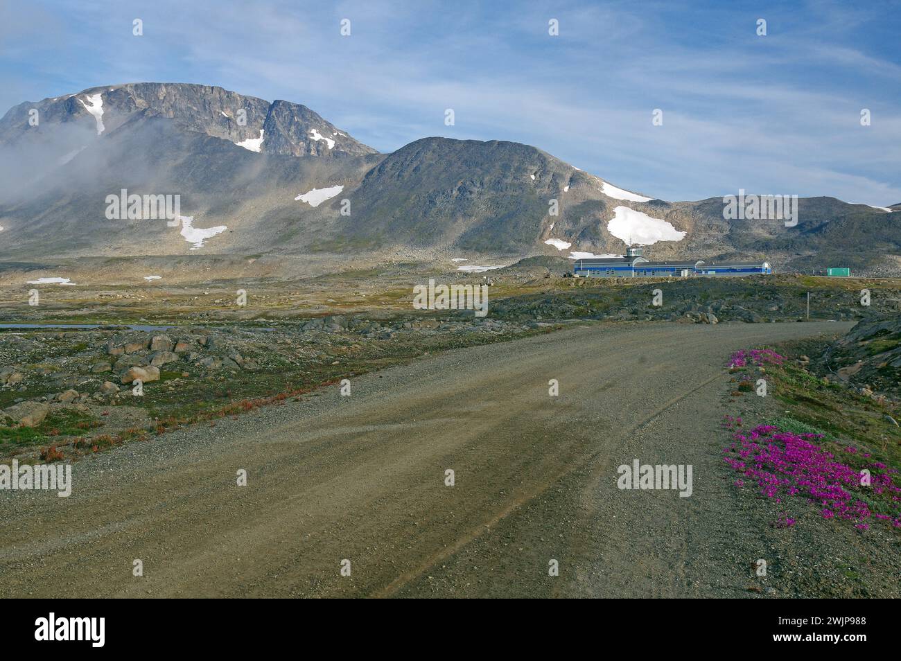 Unpaved road leads through barren landscape, Kulusuk, Arctic, Greenland ...