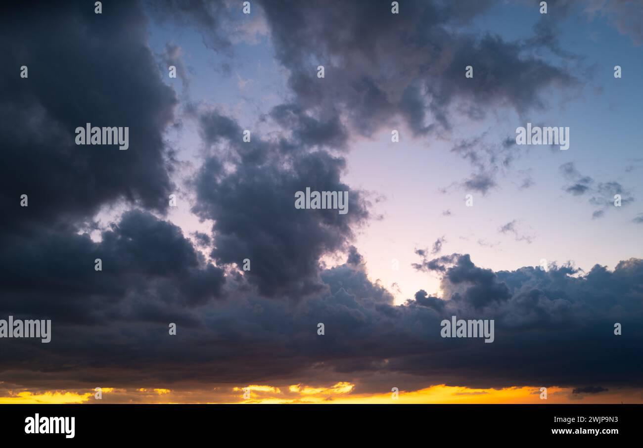 Tropical sunset. Beautiful sunset sky with clouds. Orange sunset, dark ...
