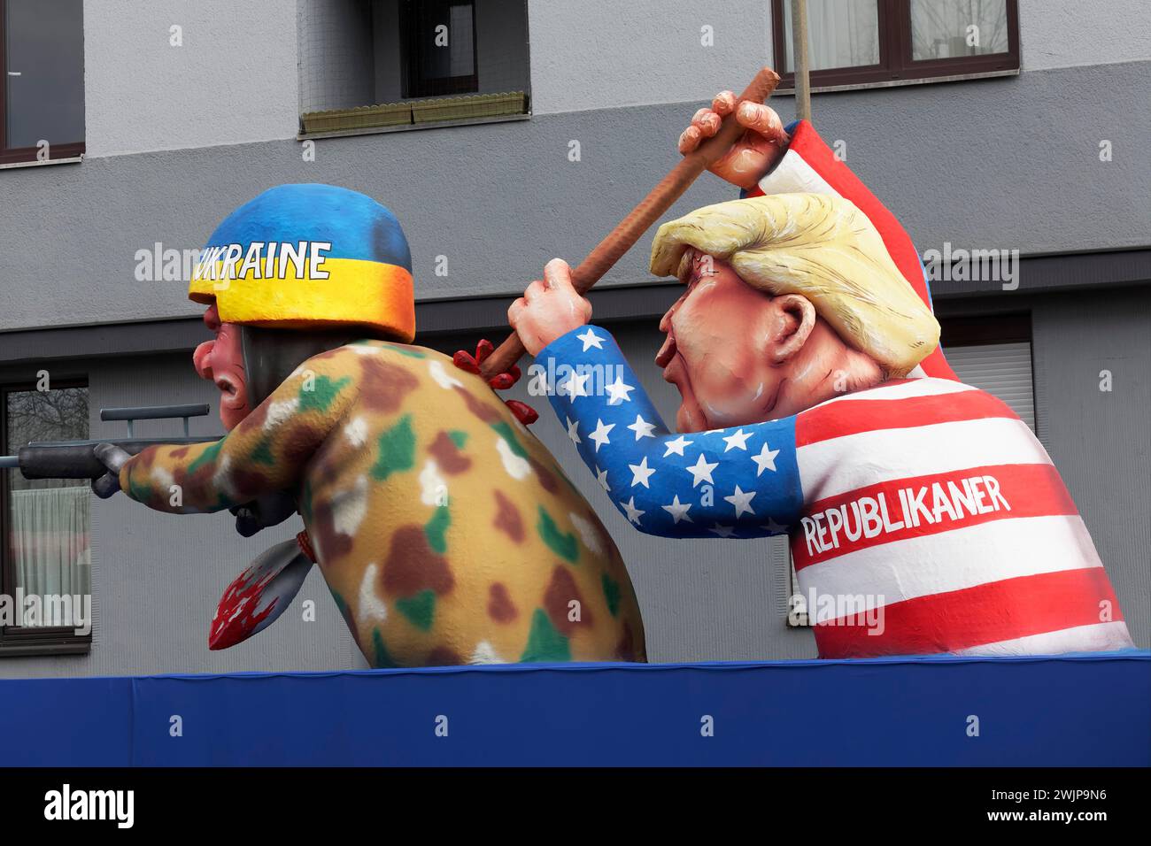 Donald Trump pierces a Ukrainian soldier with a spear, papier-mache ...