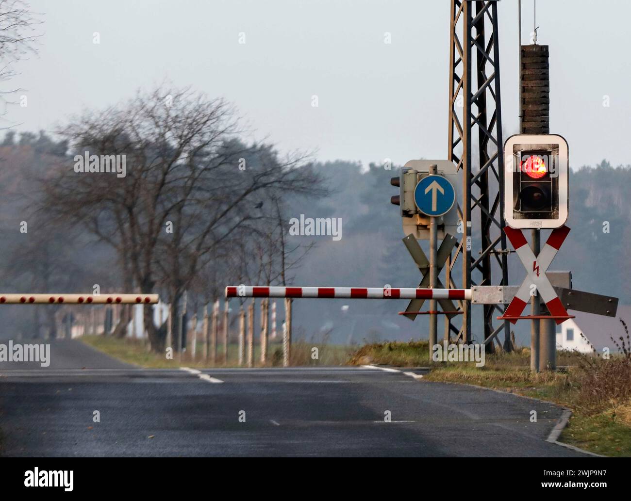 Red traffic light and barrier at a level crossing, Danewitz, 08.12.2020 ...