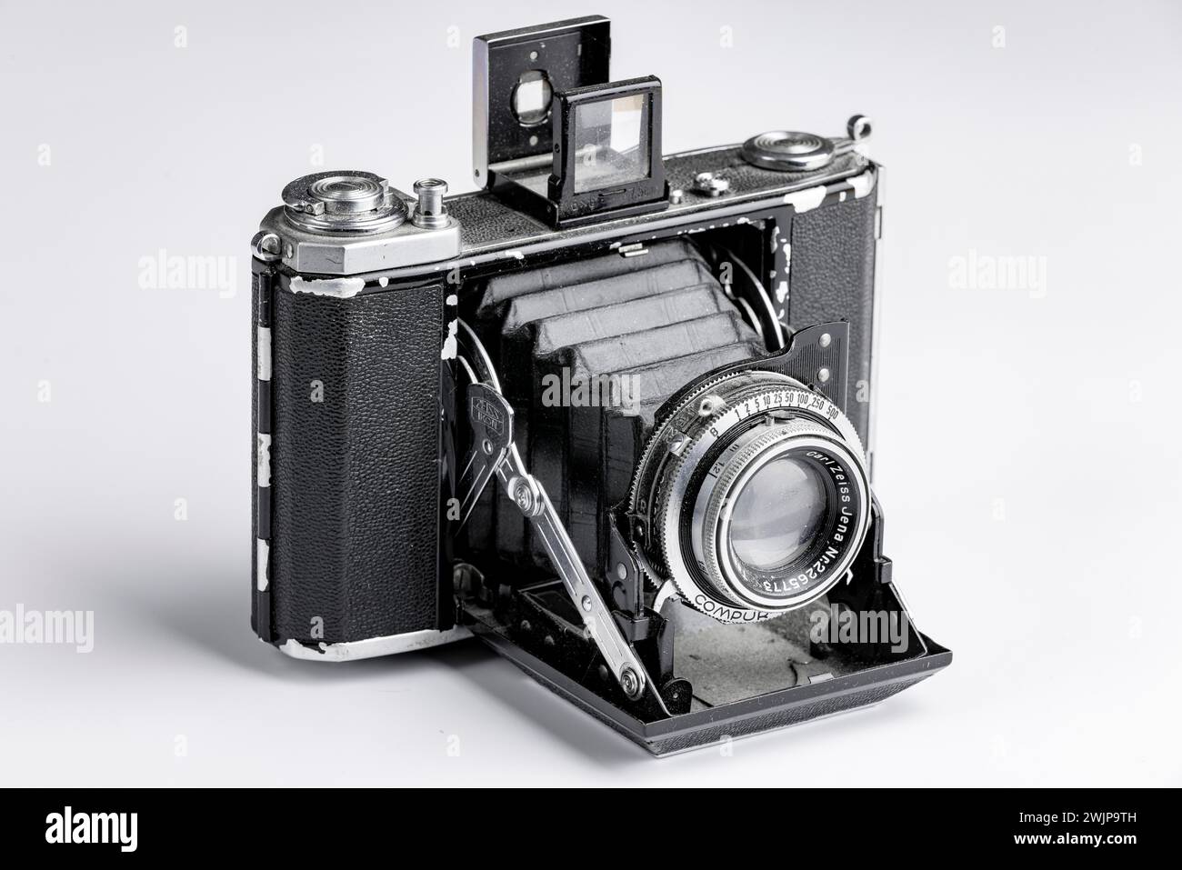 Old bellows camera with extended bellows and opened optical viewfinder ...