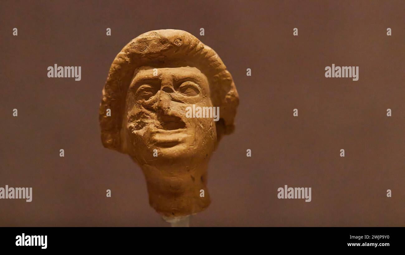 Theatre mask, statuette of a human face made of clay with accentuated ...