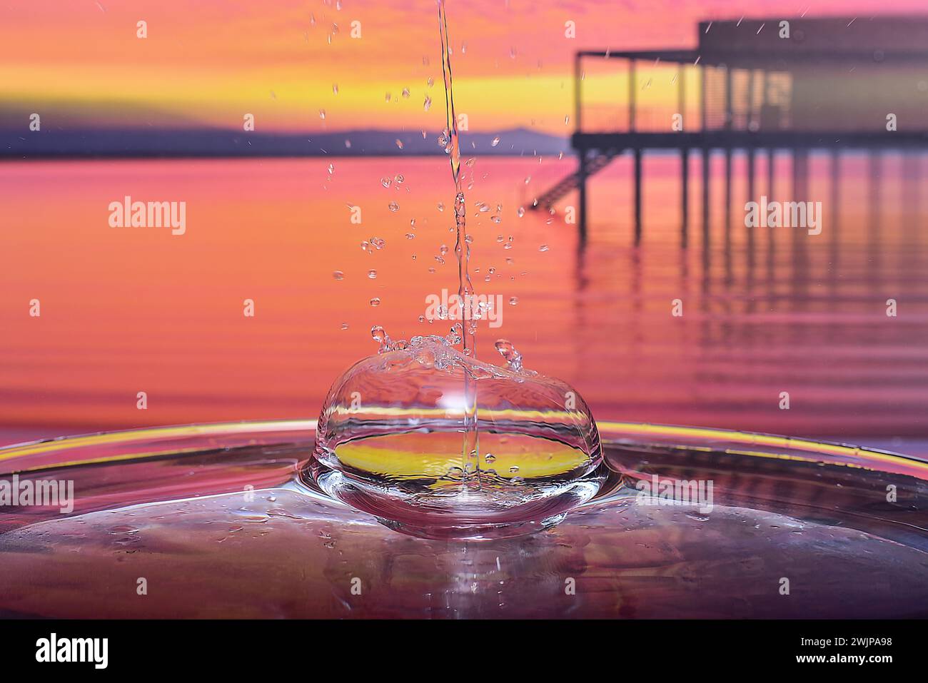 Splash of a drop falling into water, studio shot with Lake Constance ...