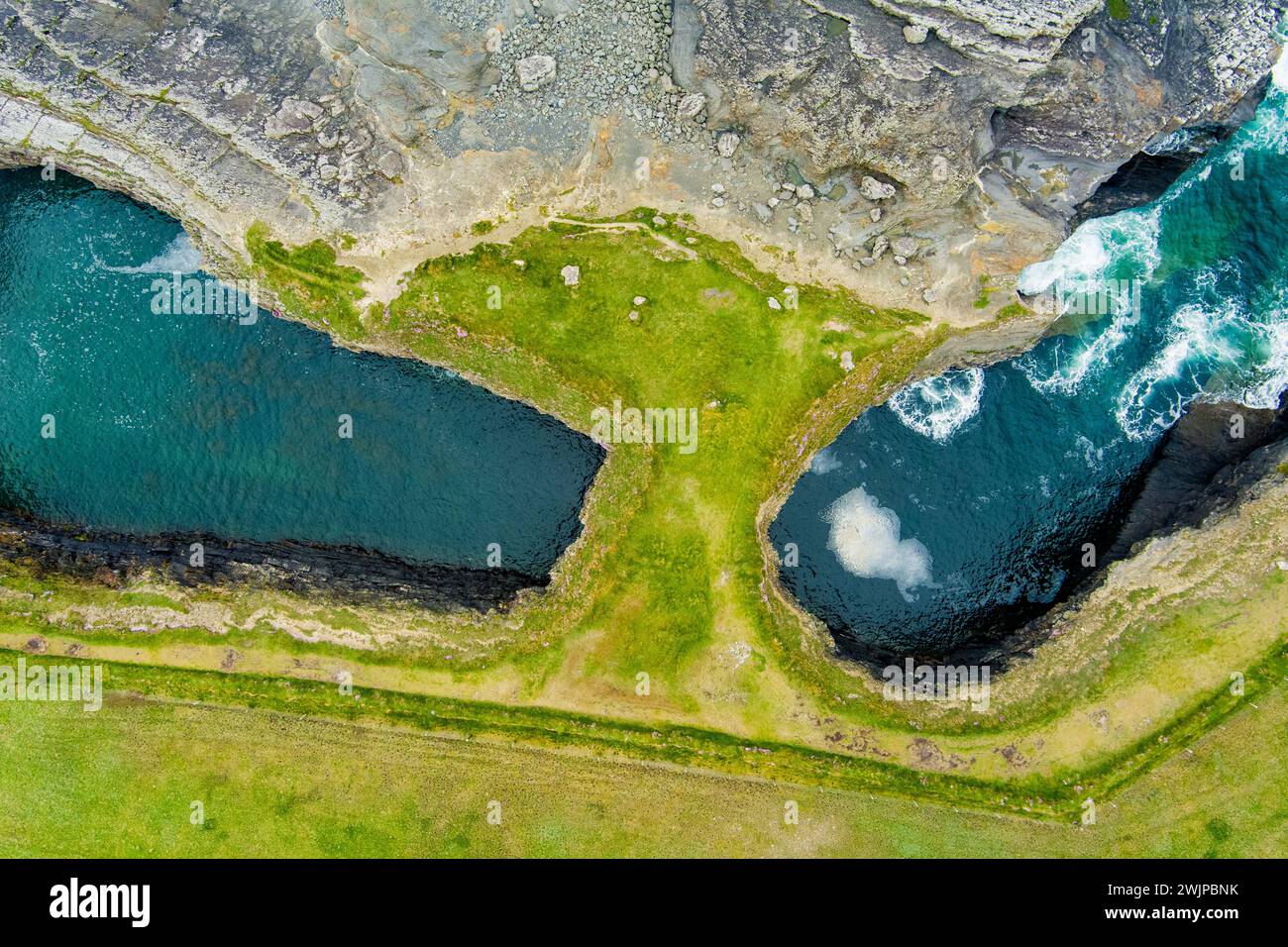 Aerial view of Bridges of Ross, three natural rock arches, carved into ...