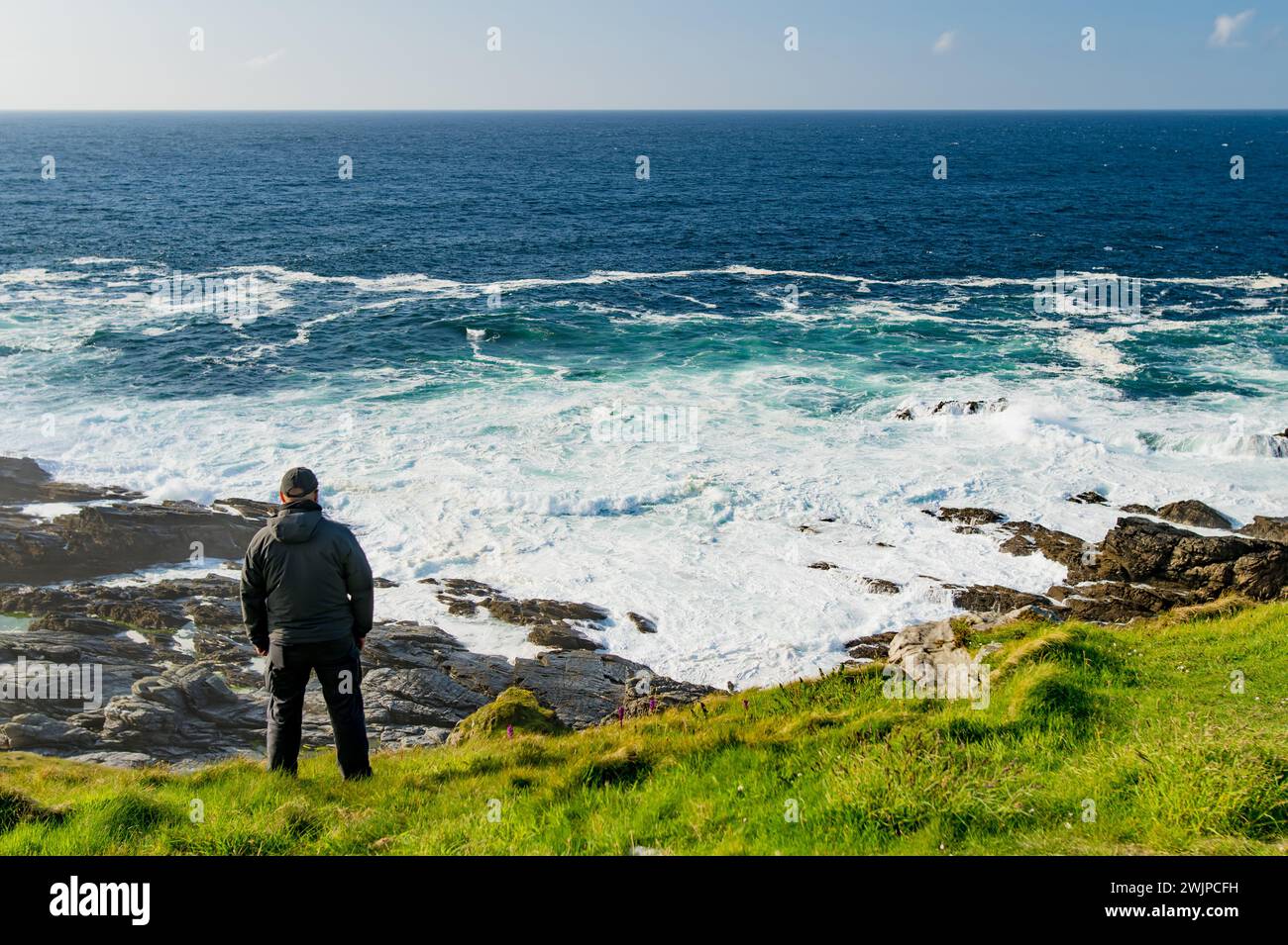 Tourist admiring scenic beauty of Malin Head, Ireland's northernmost ...
