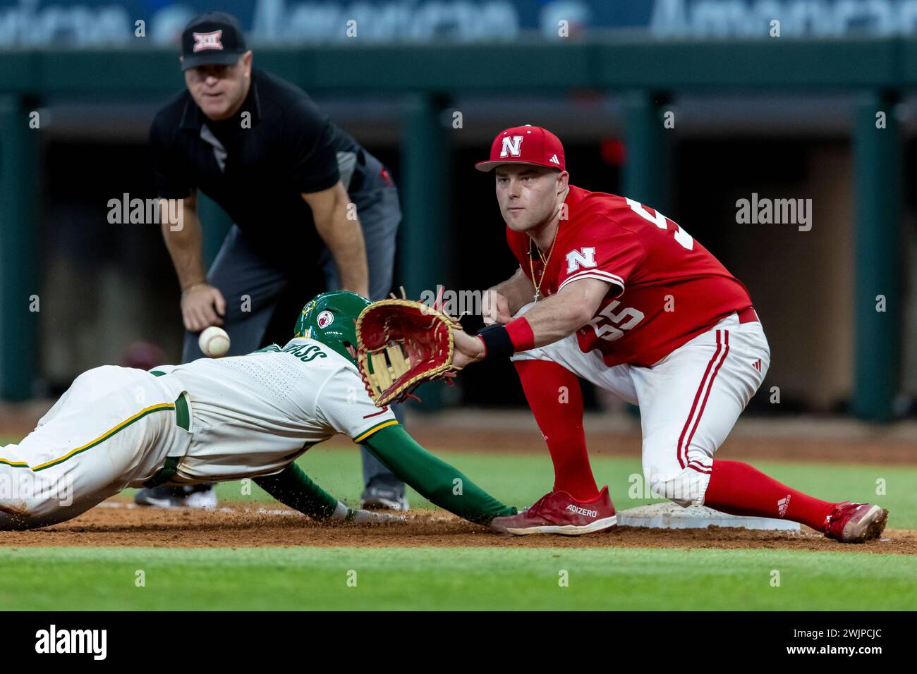 Baylor's Will Pendergrass, left, tags up of first as Nebraska first ...
