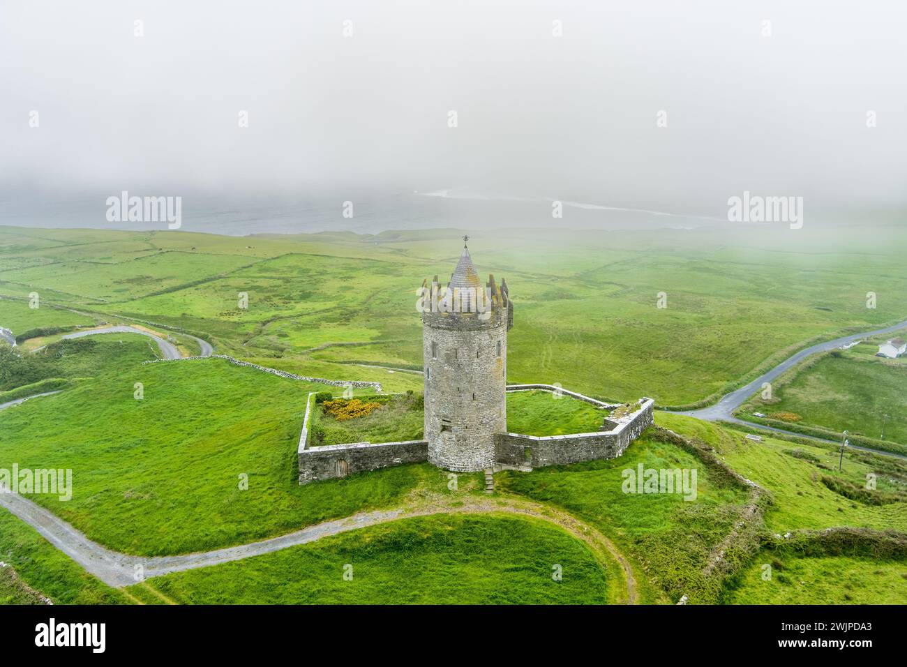 Aerial view of Doonagore Castle, round 16th-century tower house with a ...