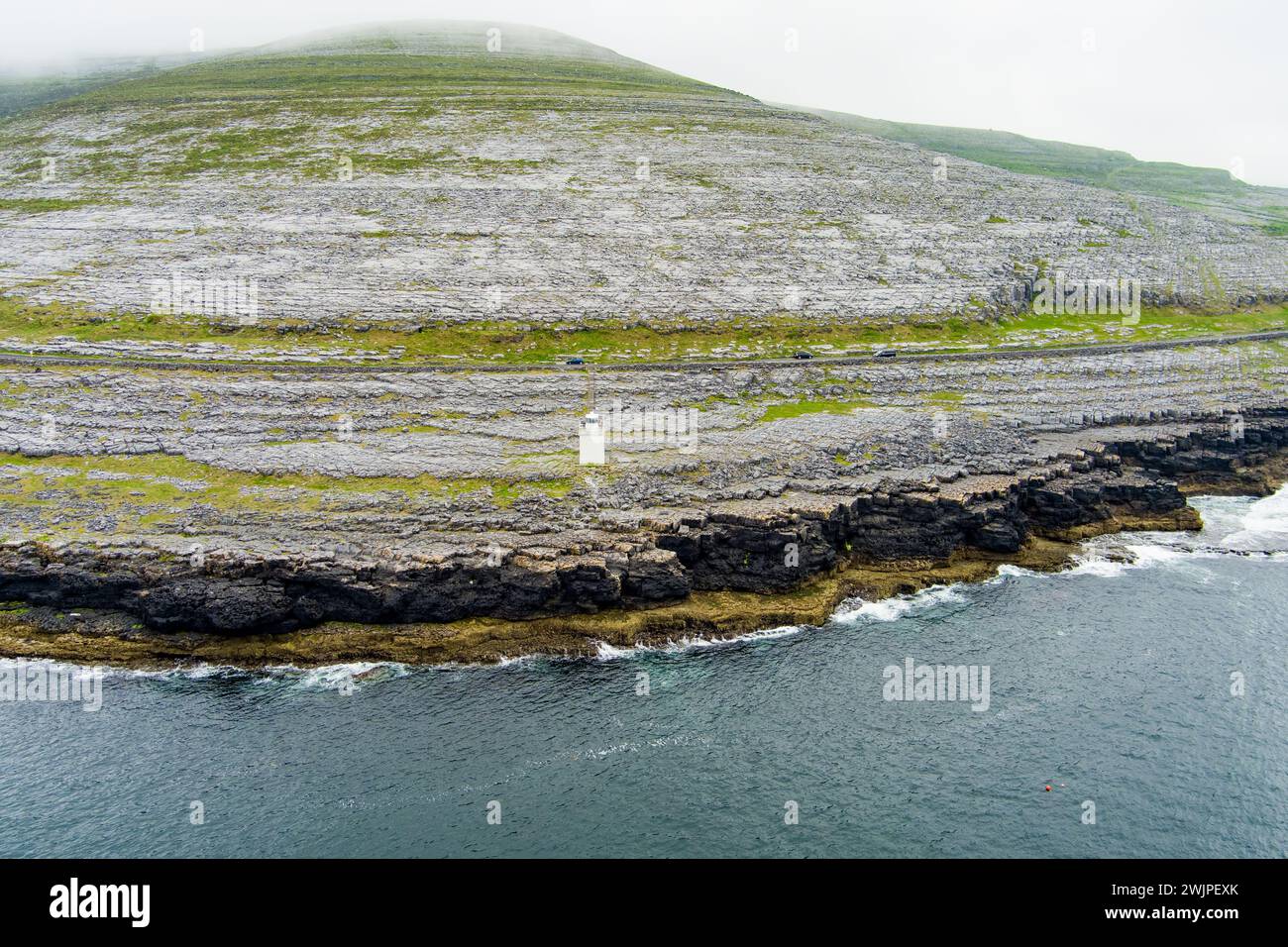 Black Head Lighthouse, situated in the rough rocky landscape of Burren ...