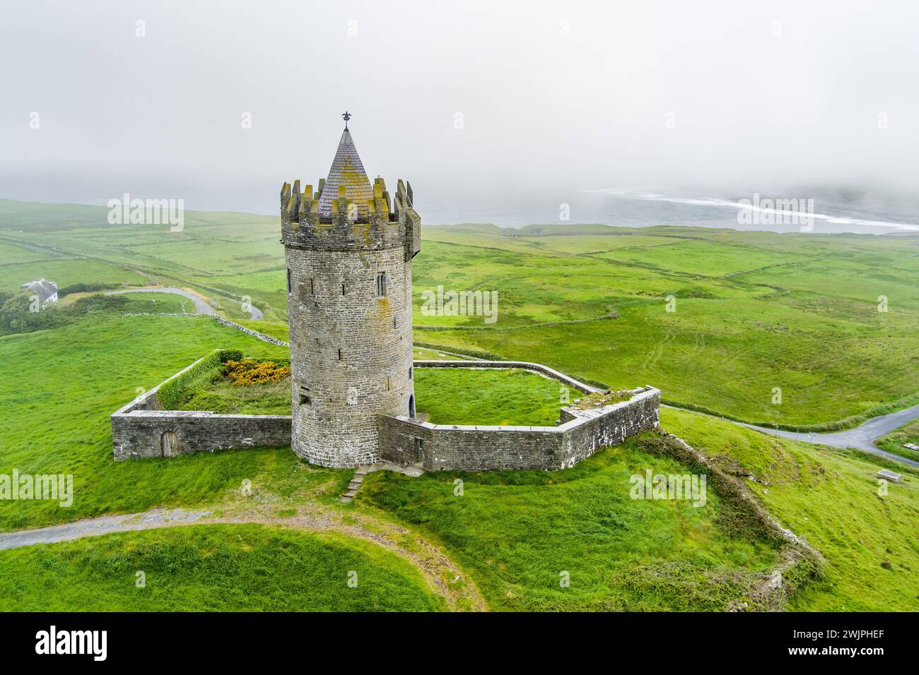 Aerial view of Doonagore Castle, round 16th-century tower house with a ...