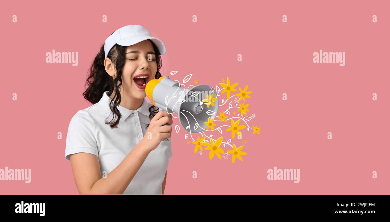 Young woman shouting into megaphone with drawn flowers on pink ...