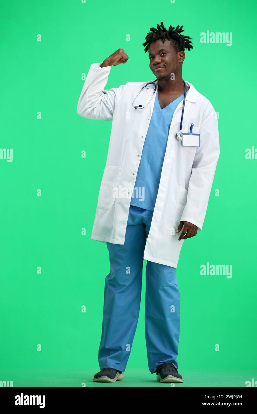 The doctor, in full height, on a green background, shows a call sign ...