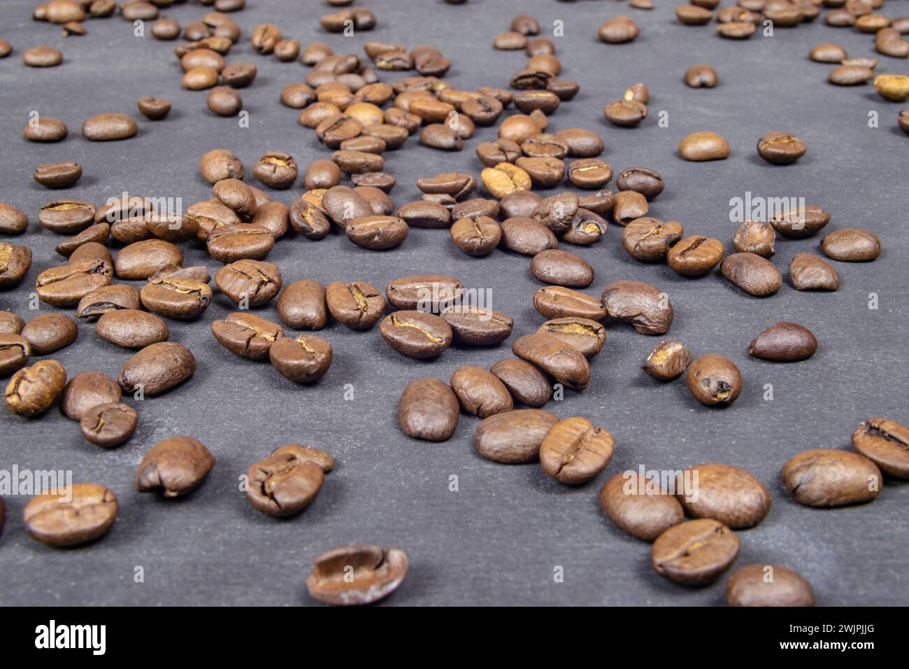 Coffee on black surface Roasted beans of Arabica Robusta Low depth of ...