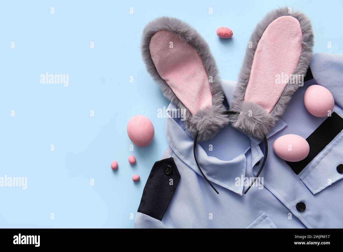 Bunny ears with Easter eggs and police officer uniform on blue ...