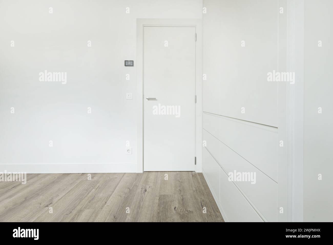 Empty room in a house with smooth walls and white wooden cabinets ...