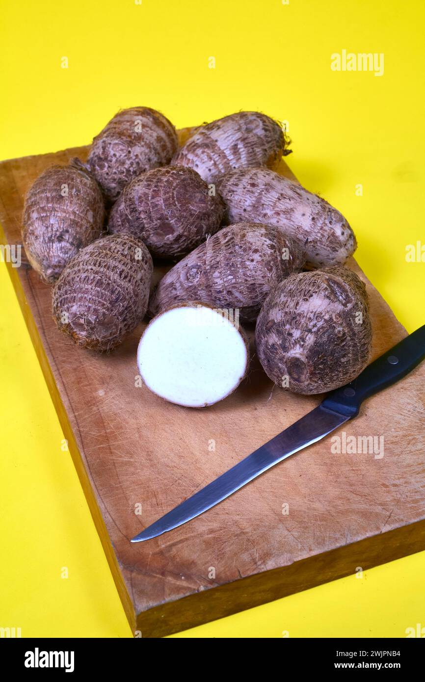 closeup of taro root vegetable, eddo malanga, hands table slice Stock ...