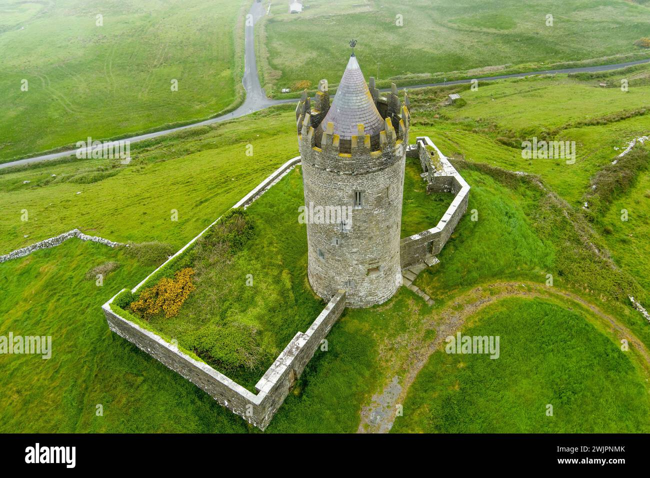 Aerial view of Doonagore Castle, round 16th-century tower house with a ...