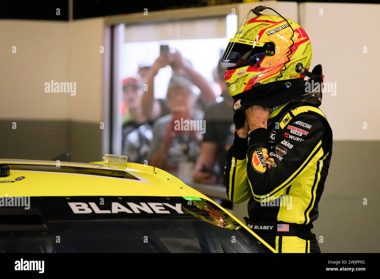 Ryan Blaney adjusts his helmet before getting into his car before a ...