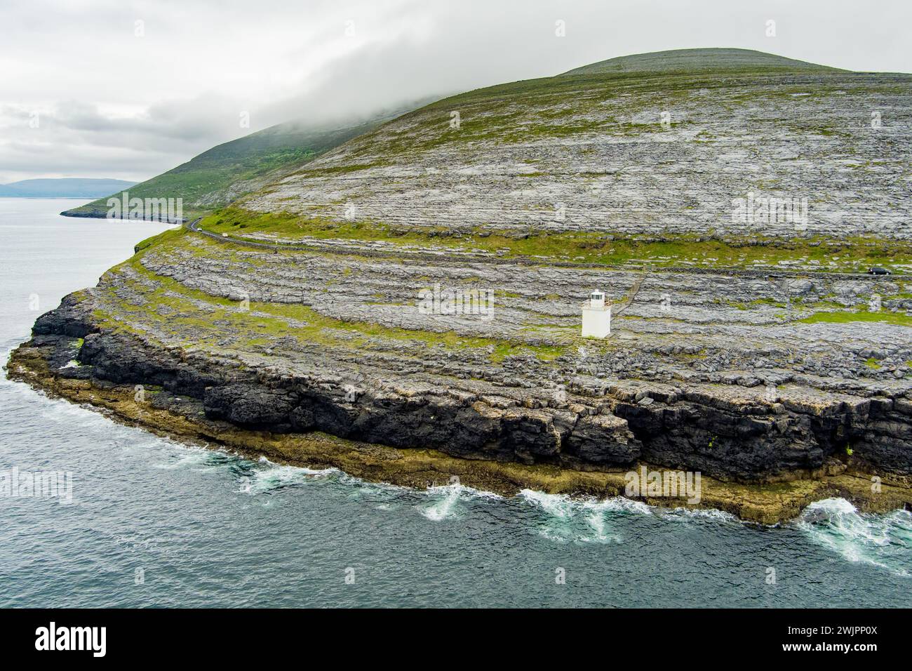 Black Head Lighthouse, situated in the rough rocky landscape of Burren ...