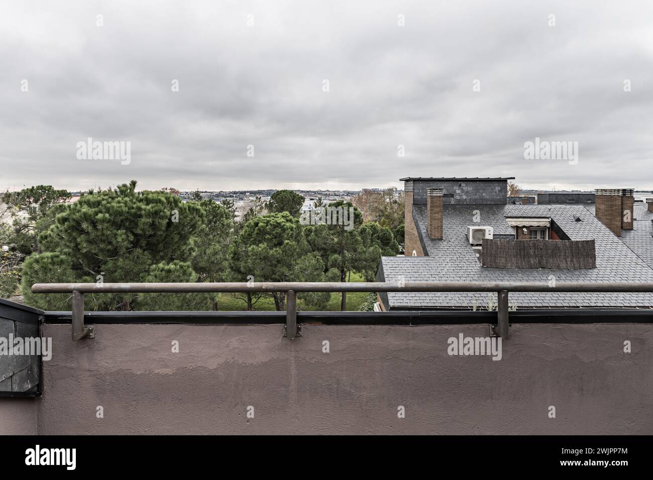 Terrace of a house in front of others with sloping roofs of a house ...