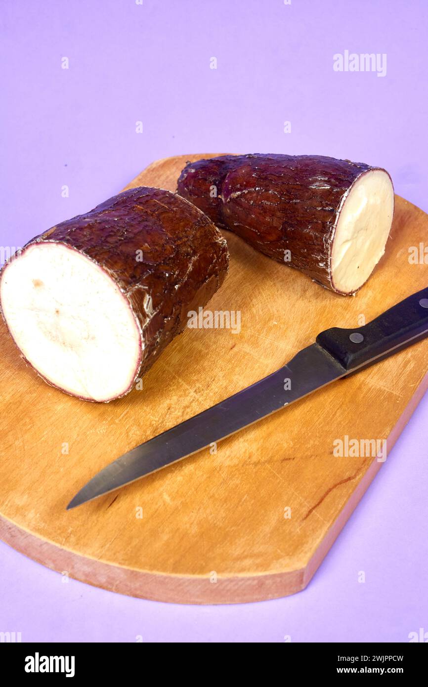 Fresh Organic Cassava Root, Manioc Esculenta, yuca On purple Background ...