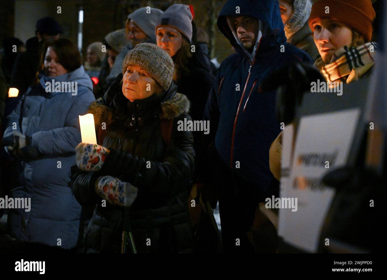 People attend a vigil for Alexei Navalny outside the Russian consulate ...