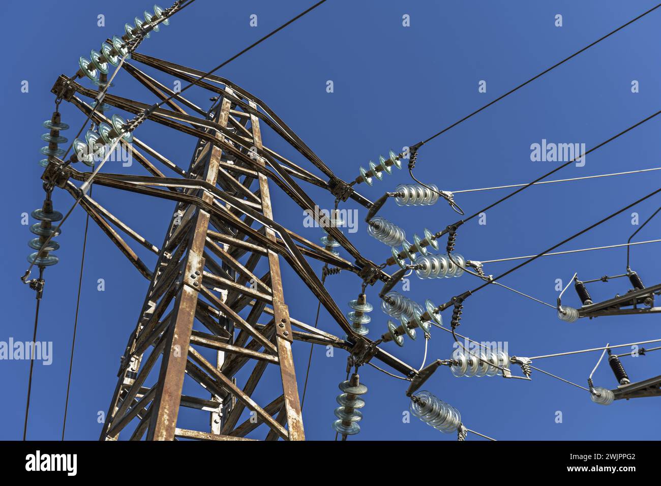 A high voltage tower carrying electricity through its cables with bell ...