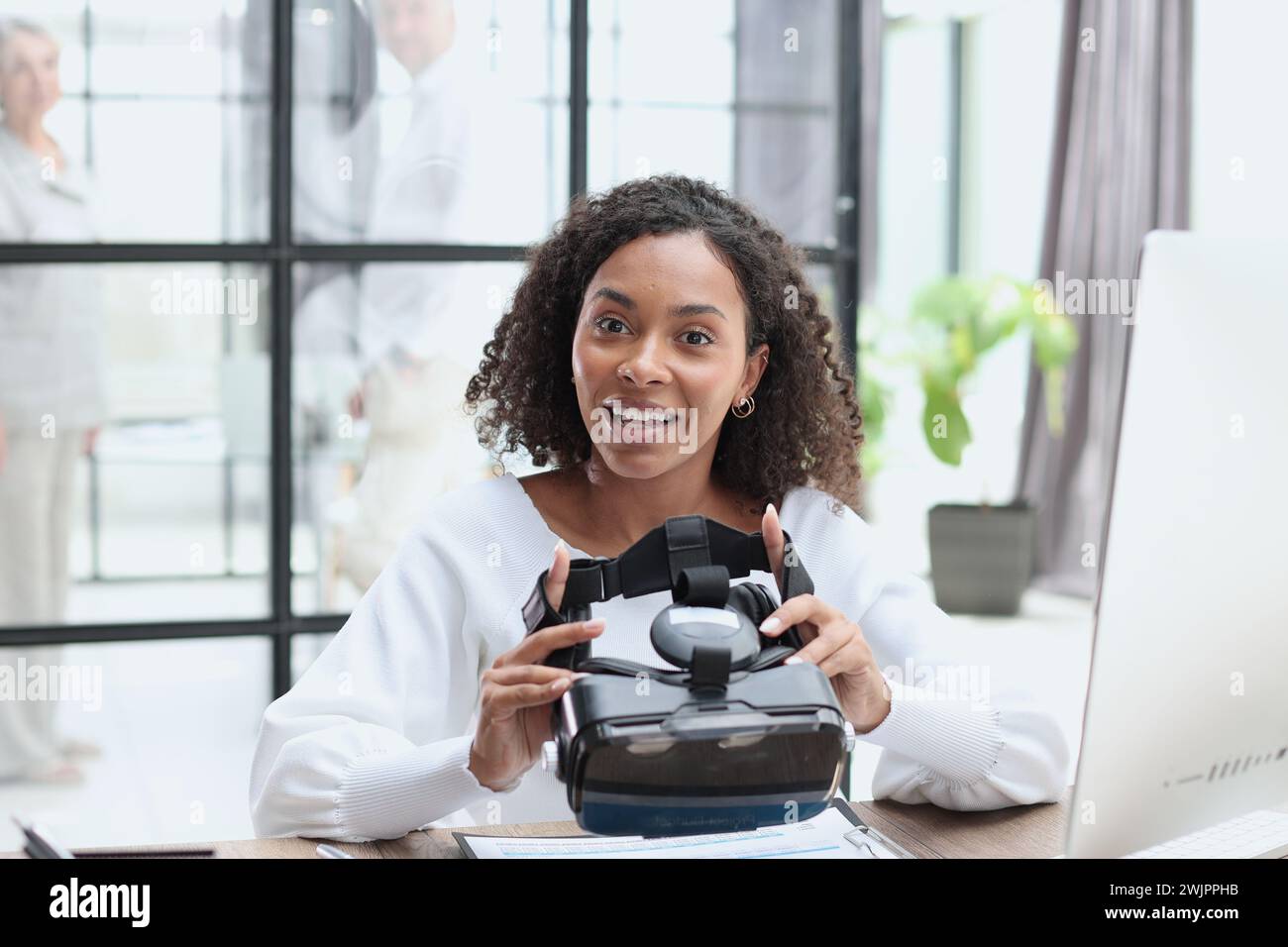 Girl in VR glasses of virtual reality with gamepad playing game Stock ...