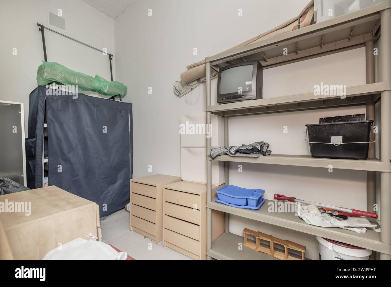 A small storage room with shelves and antique furniture in an annex of ...