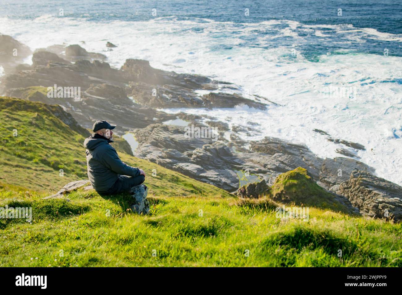 Tourist admiring scenic beauty of Malin Head, Ireland's northernmost ...