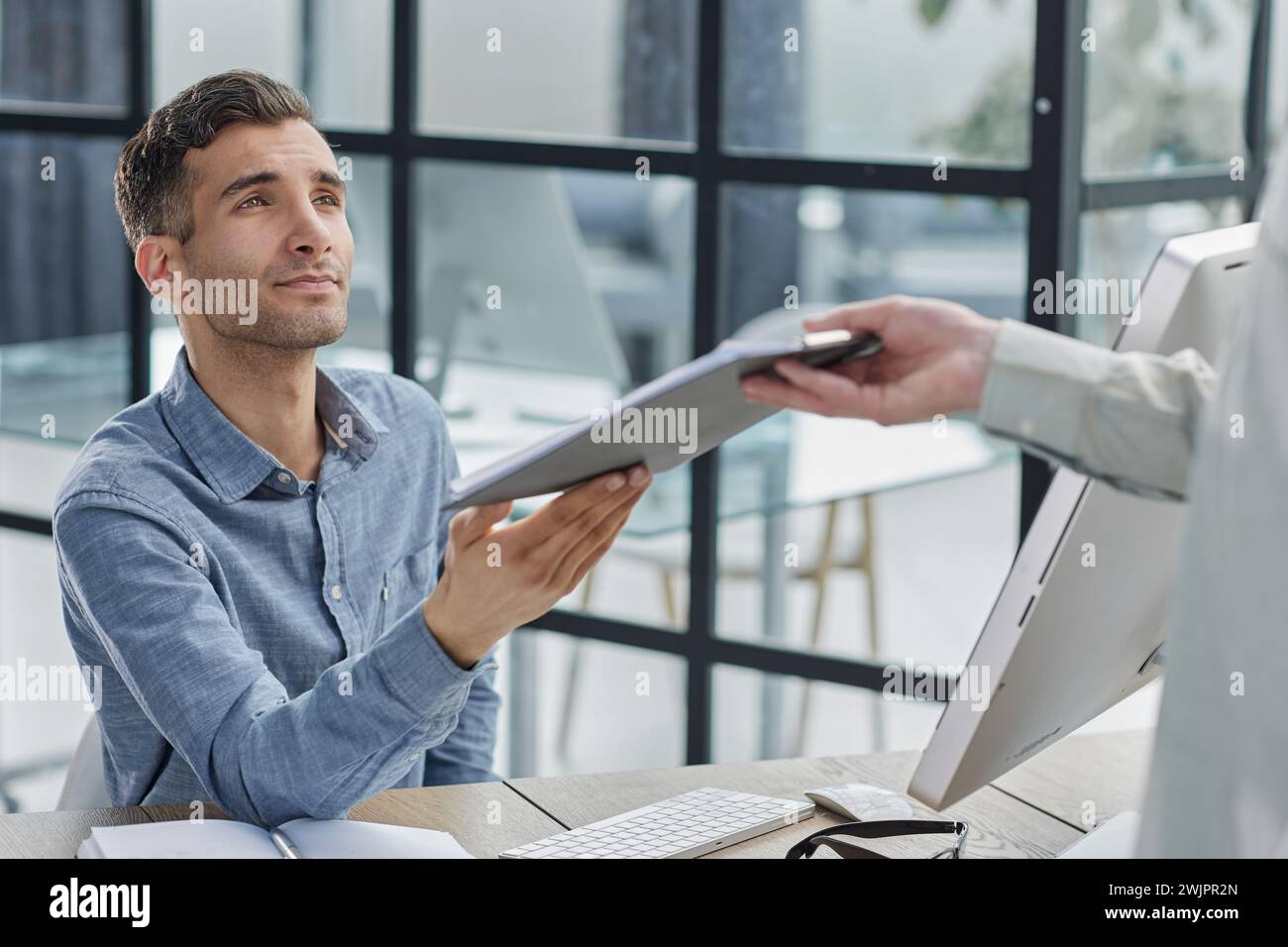 Focus on male hands passing each other folder with papers Stock Photo ...