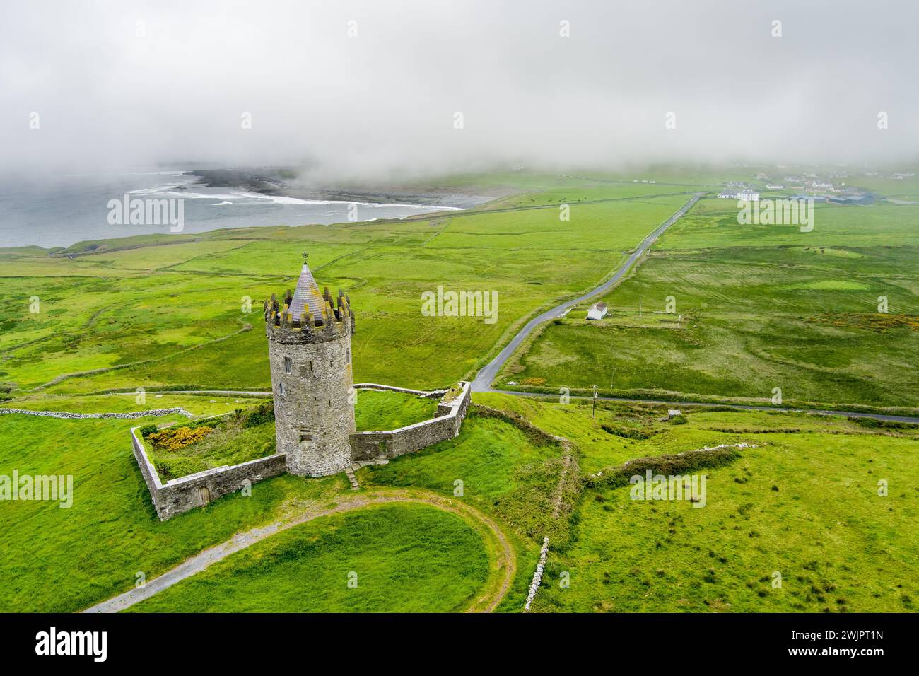 Aerial view of Doonagore Castle, round 16th-century tower house with a ...