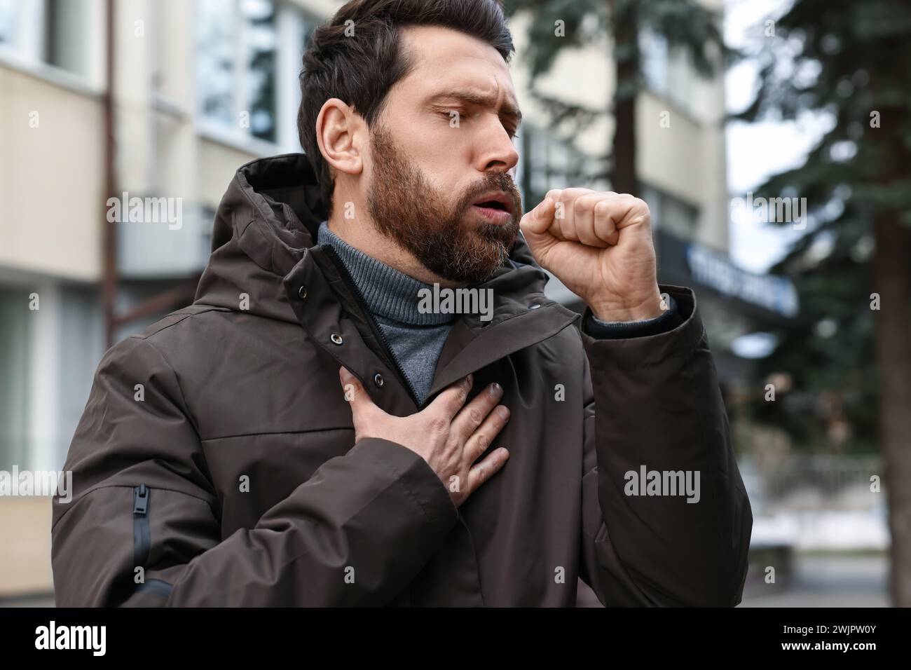 Sick man coughing on city street. Cold symptoms Stock Photo - Alamy