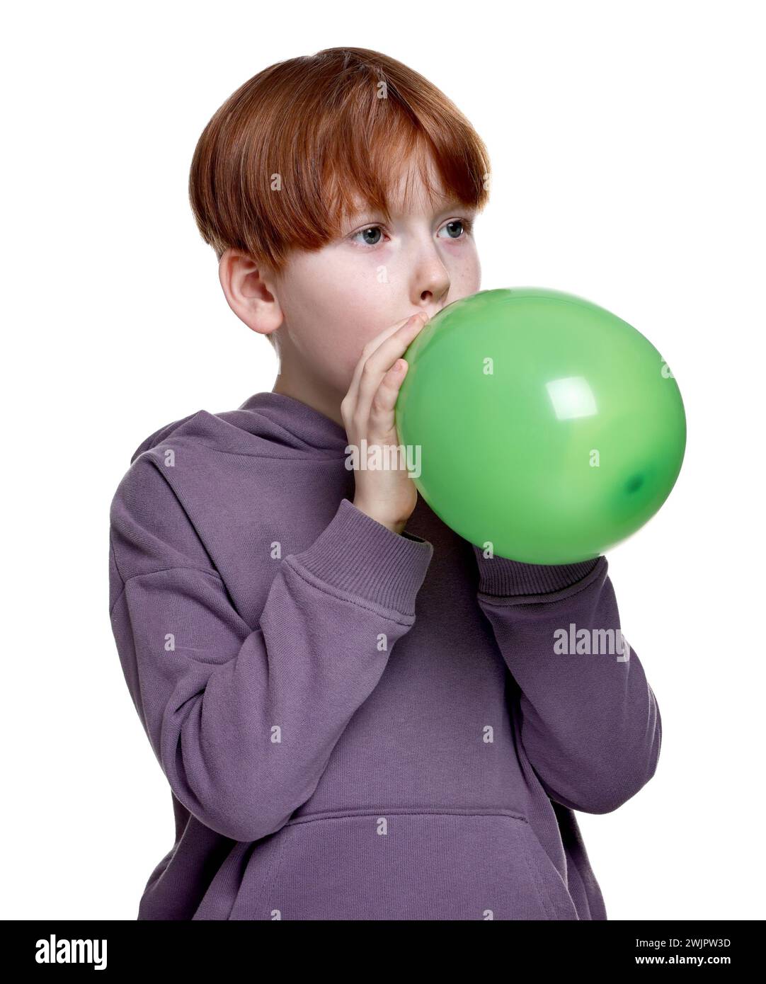 Boy inflating green balloon on white background Stock Photo - Alamy