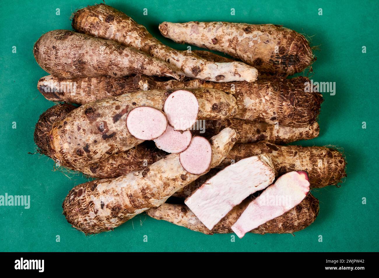 closeup of taro root vegetable, eddo malanga, hands table slice Stock ...
