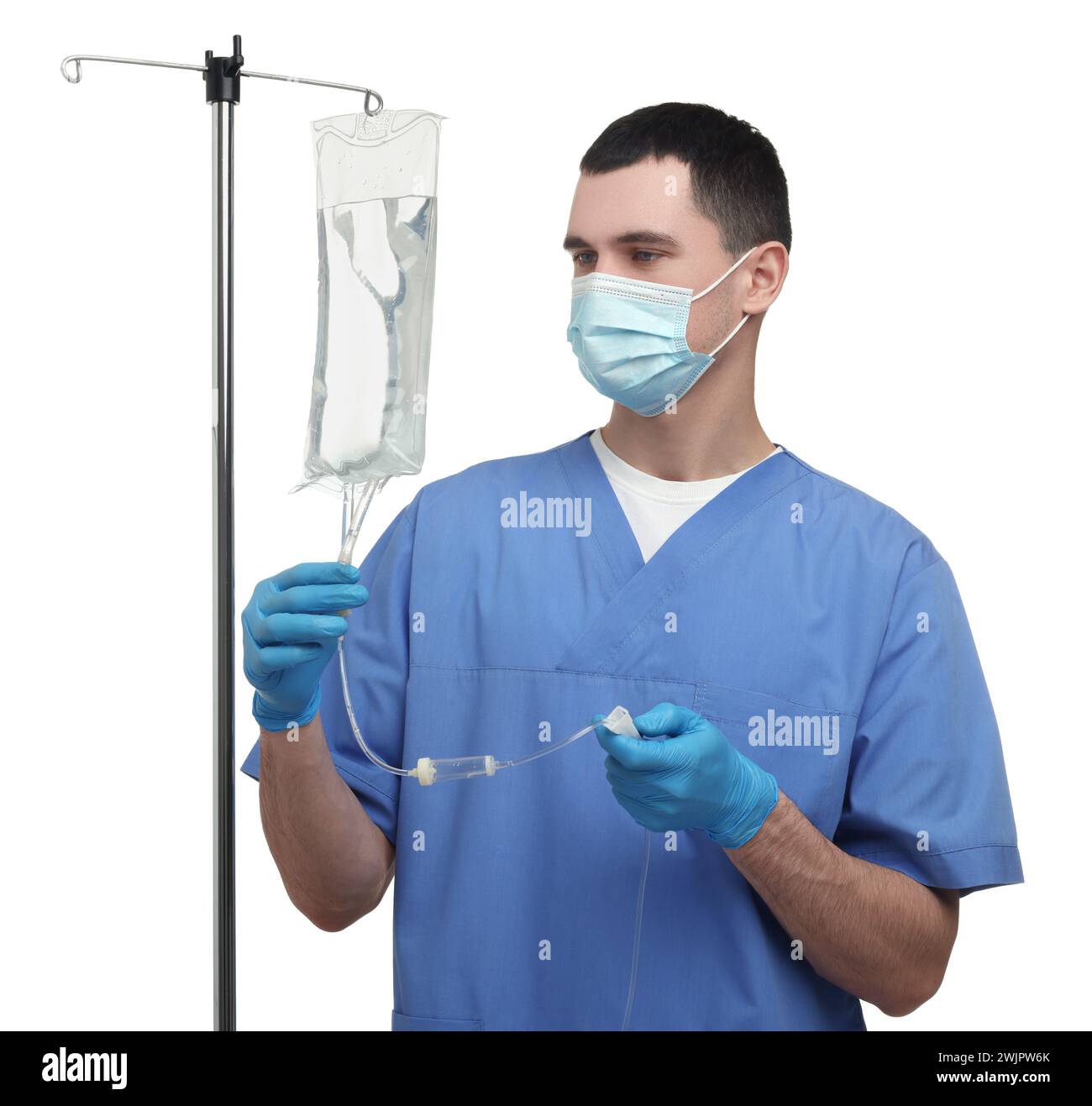 Nurse setting up IV drip on white background Stock Photo - Alamy