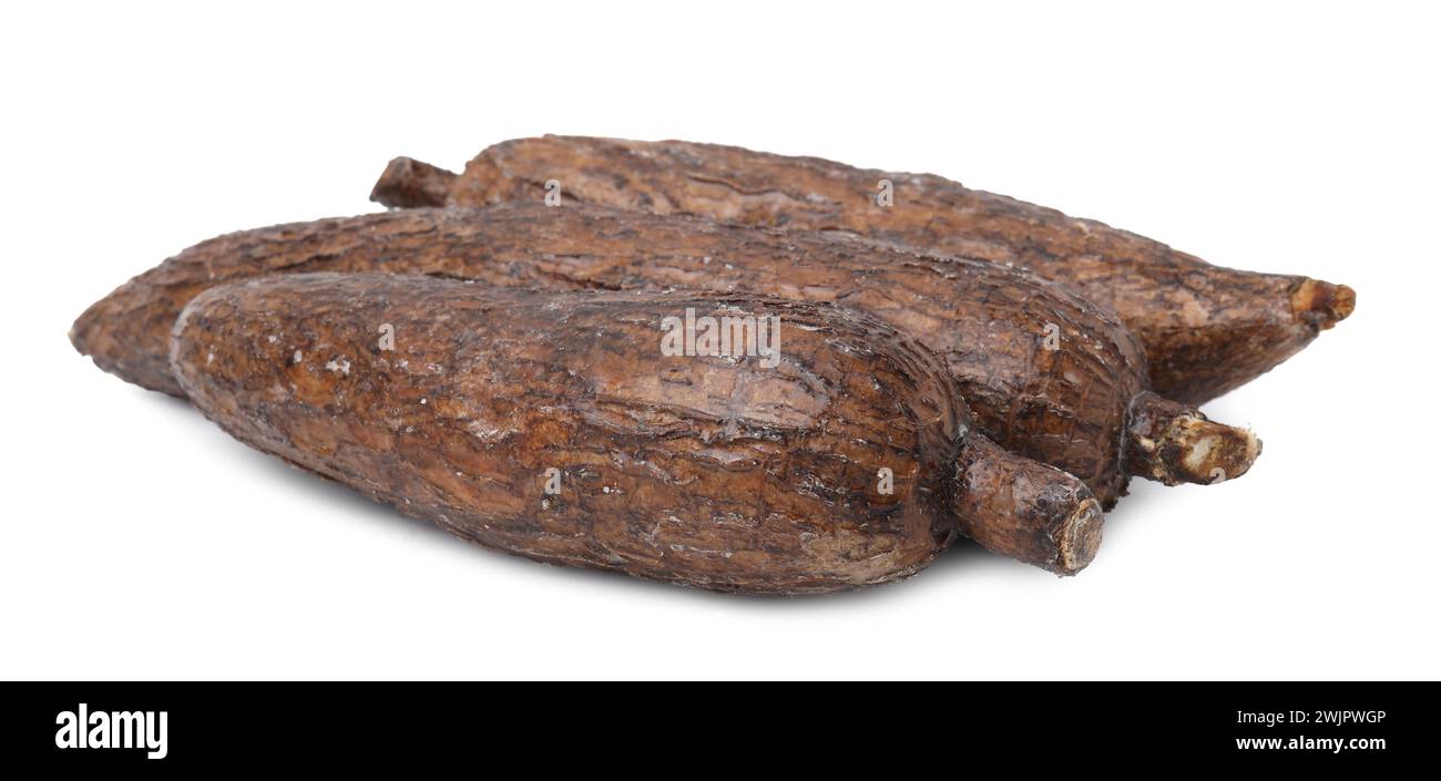 Three whole ripe cassava roots isolated on white Stock Photo - Alamy
