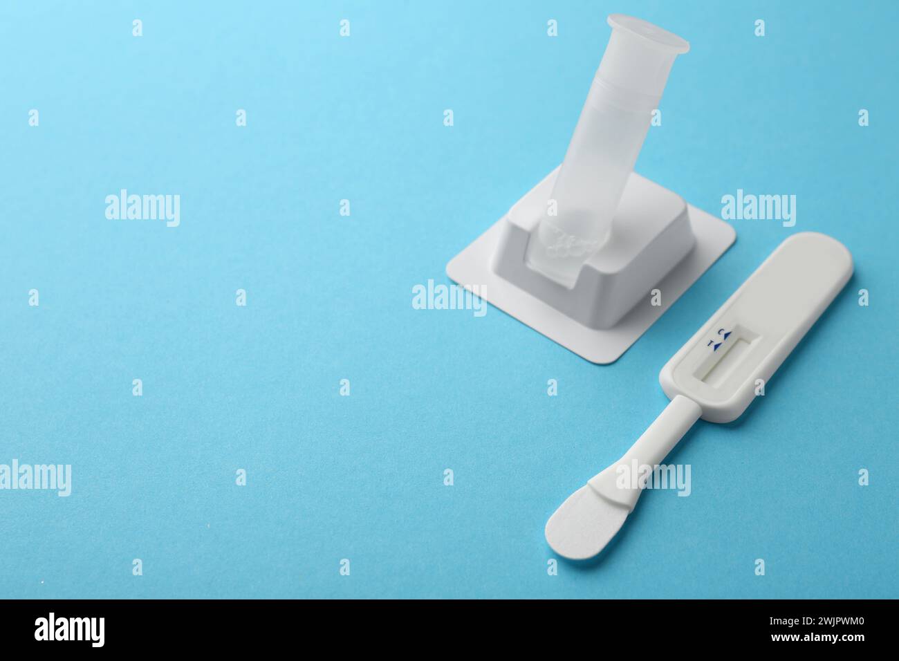 Disposable express test kit on light blue background. Space for text ...