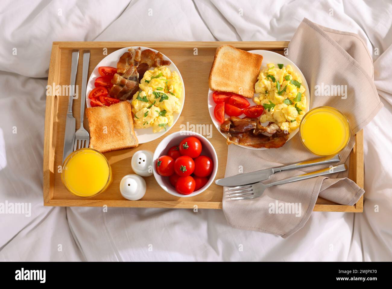 Good morning. Tray with tasty breakfast on bed, top view Stock Photo ...