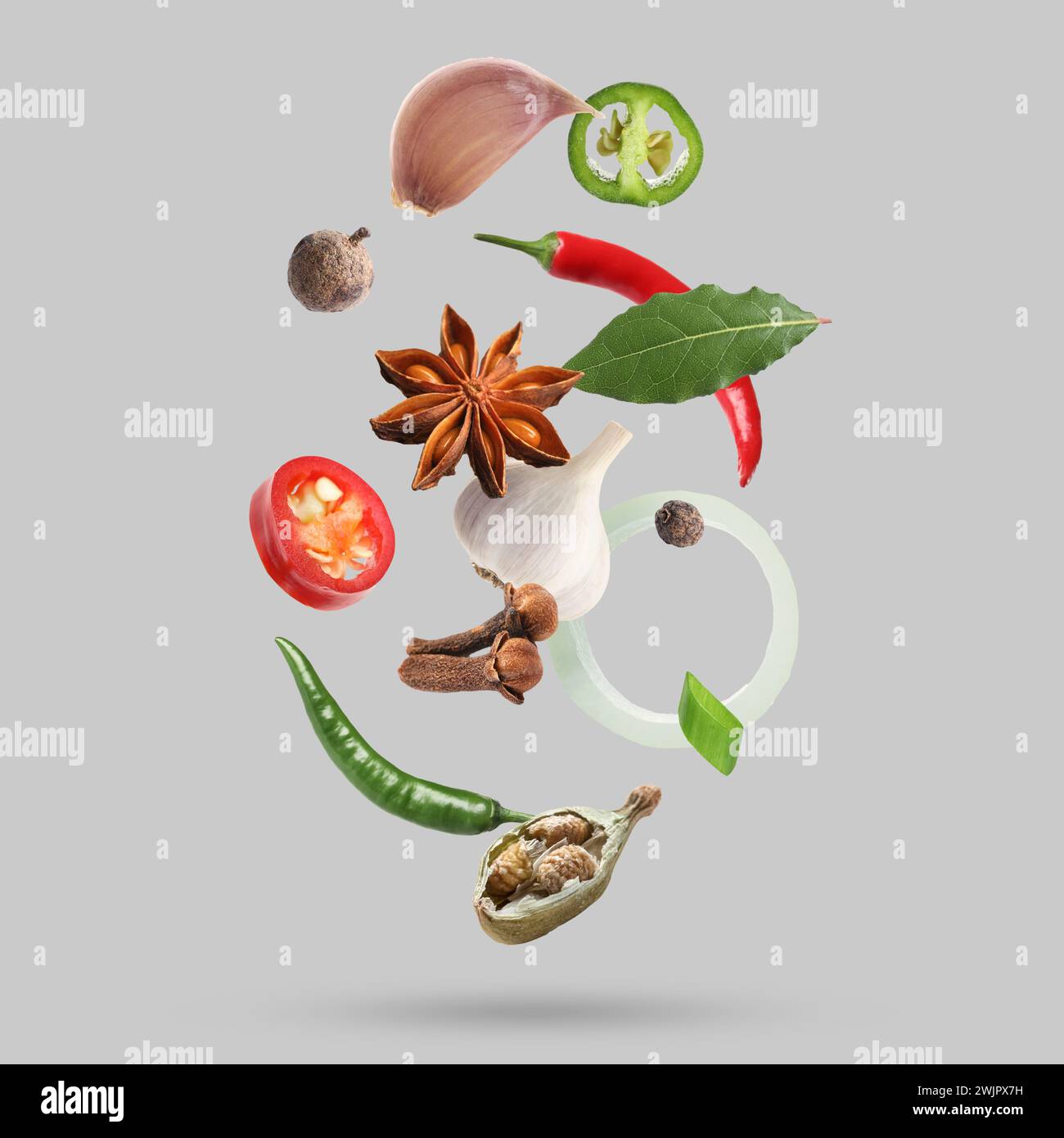 Different spices falling on light grey background Stock Photo - Alamy