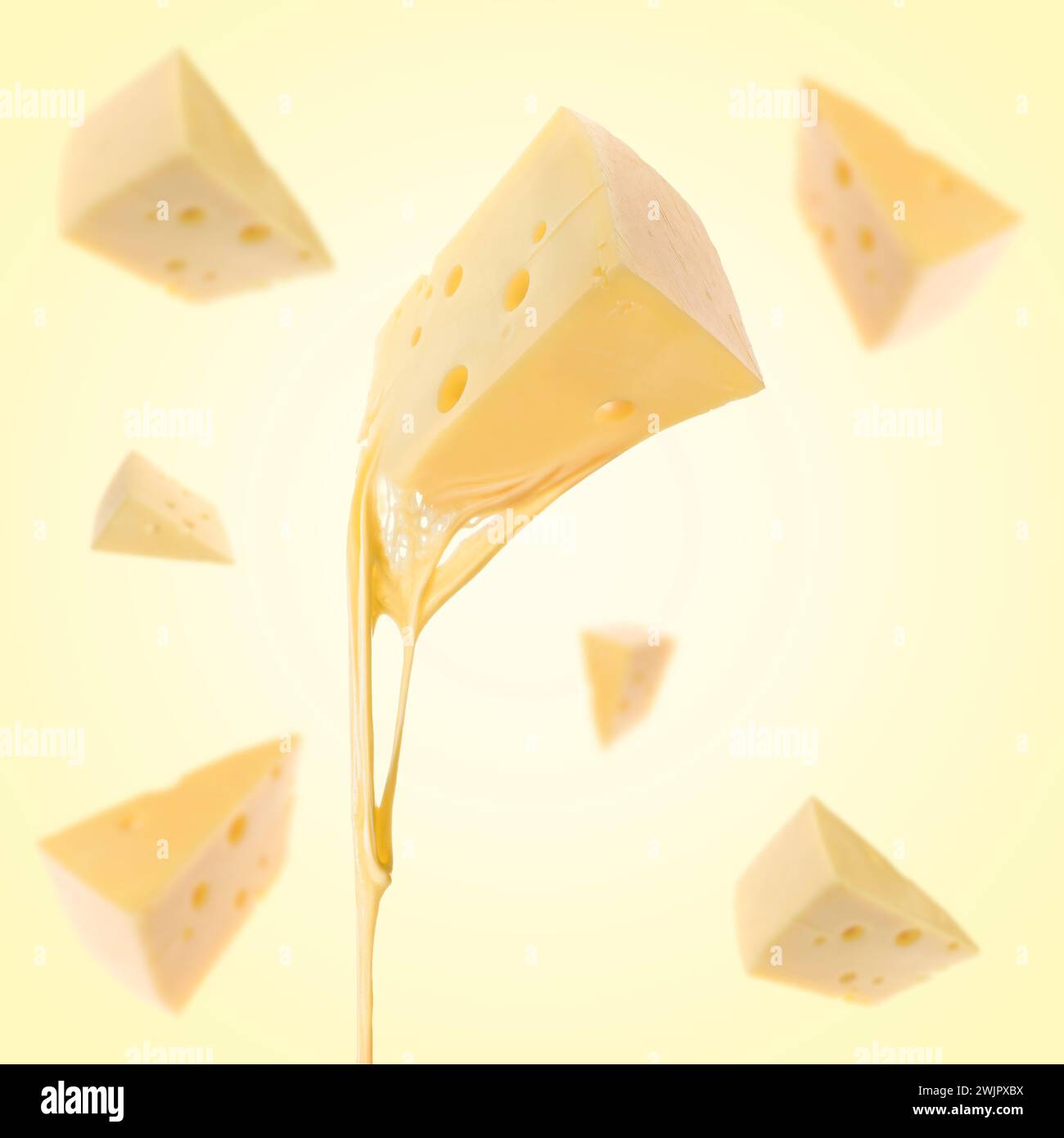 Pieces of cheese falling on yellow background Stock Photo - Alamy