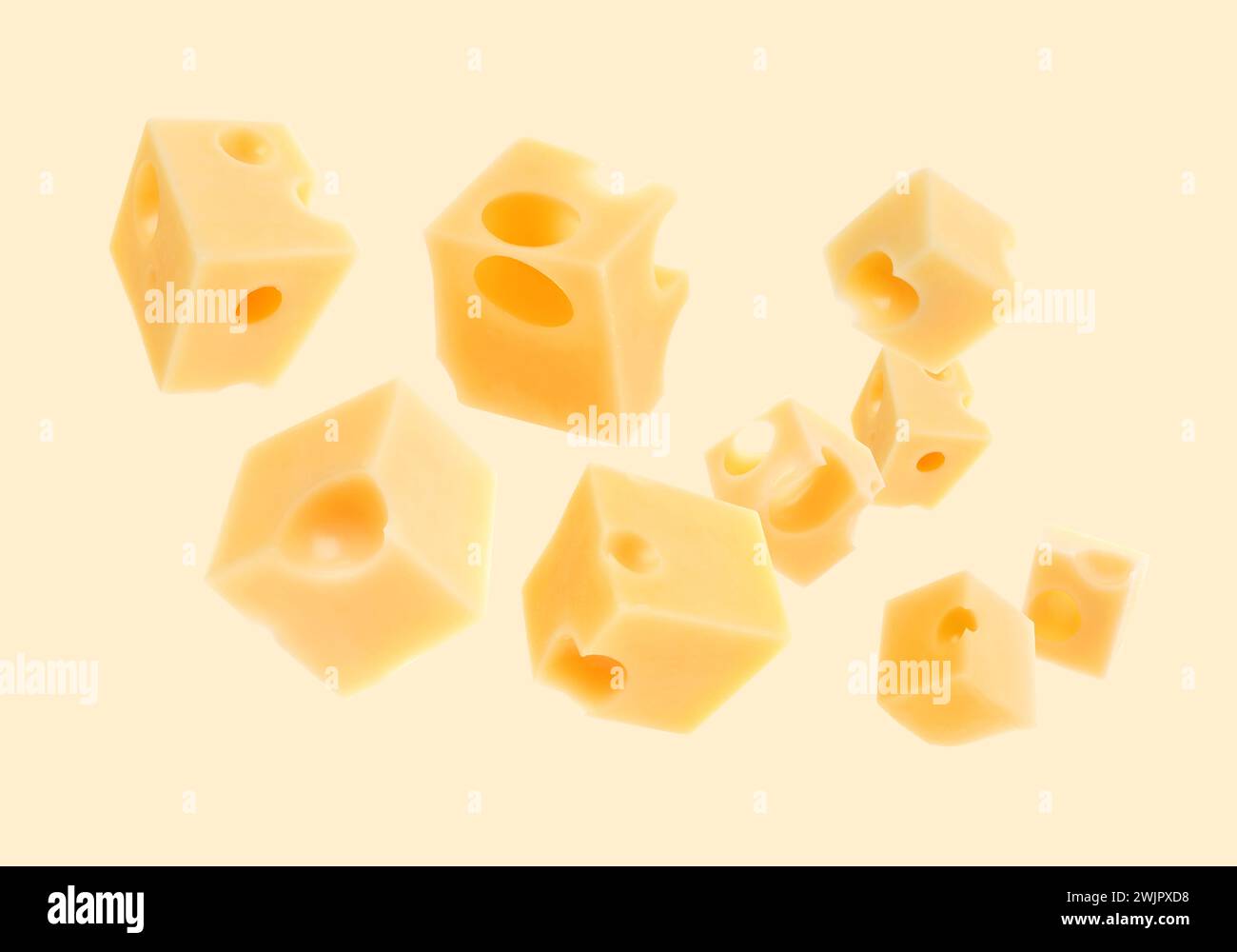 Pieces of cheese flying on beige background Stock Photo - Alamy